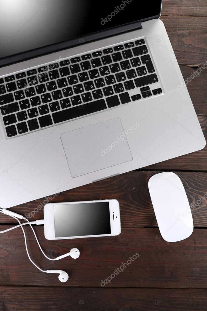 Computer peripherals and laptop accessories on wooden background ...