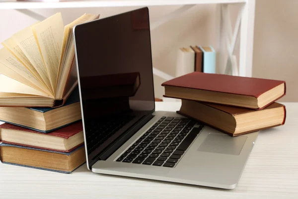 Stack of books with laptop Stock Photo by ©billiondigital 118714404