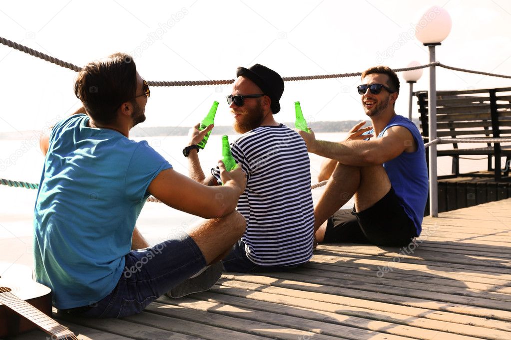 Young Men Sitting Dock Talking Each Other — Stock Photo © belchonock ...