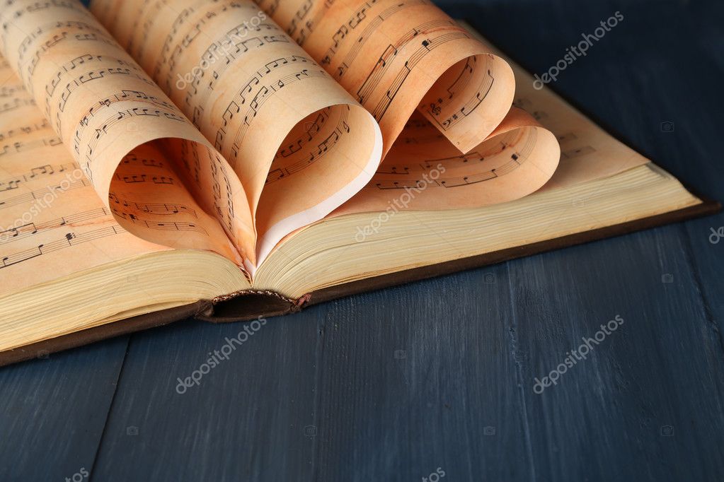 Book pages curved into hearts shapes on table close up Stock Photo by ...