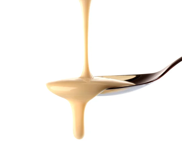 Condensed milk pouring from spoons, isolated on white Stock Photo by ...