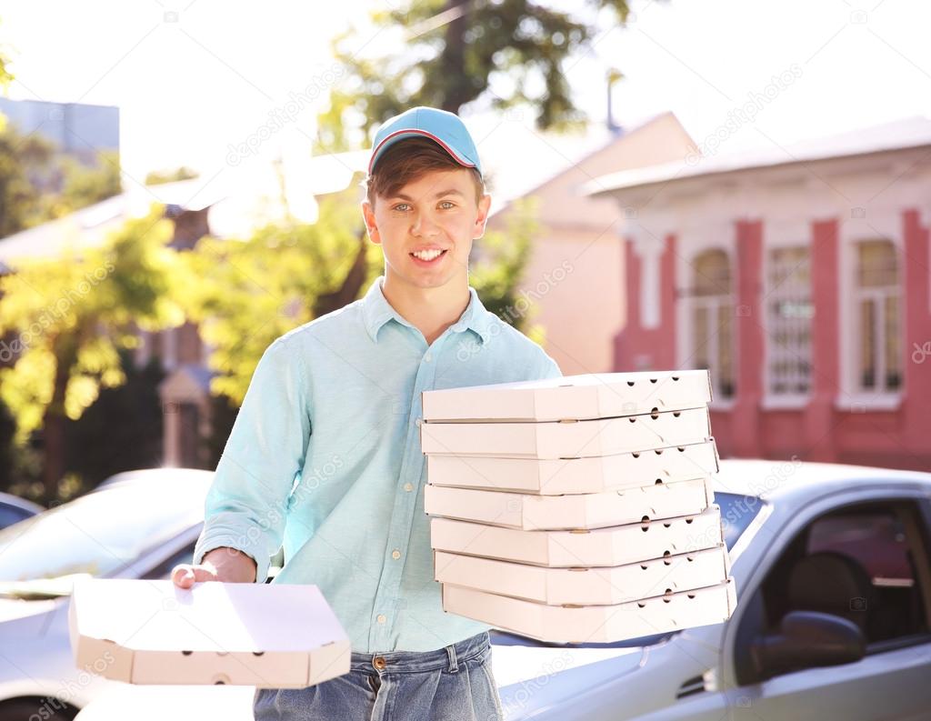 Delivery boy with pizza boxes Stock Photo by ©belchonock 94342652