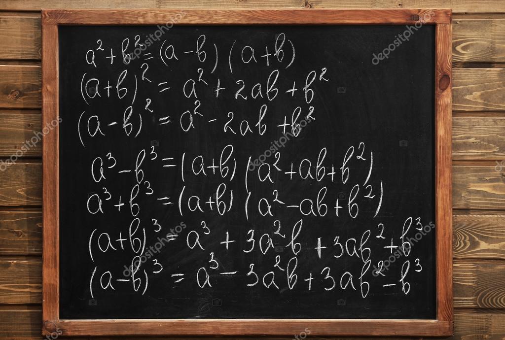 School blackboard with formulas on a brick wall — Stock Photo ...