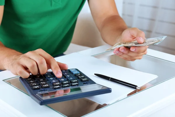 Hands Calculating money Stock Photo by ©belchonock 88840440