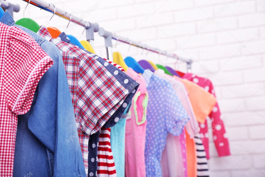 Children clothes on hangers Stock Photo by ©belchonock 96038728