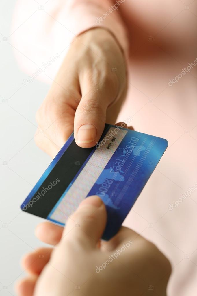 Hands holding blue credit card Stock Photo by ©belchonock 96207746