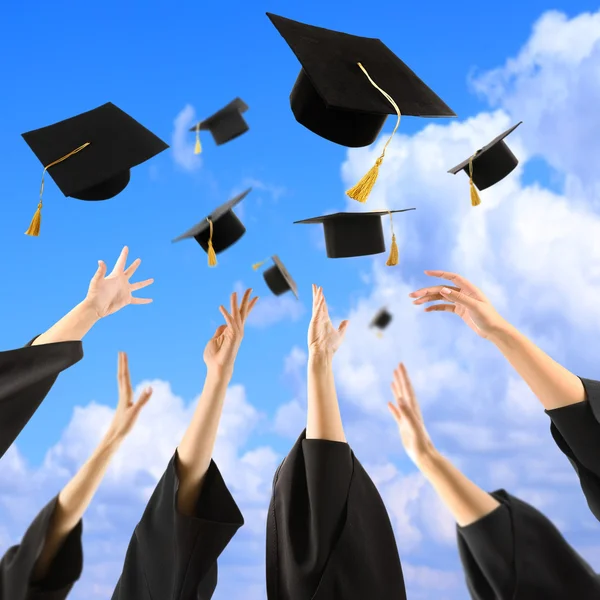 Graduates hands throwing graduation hats Stock Photo by ©belchonock ...