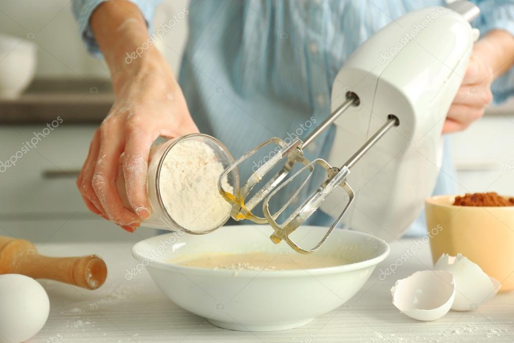 Woman adding flour Stock Photo by ©belchonock 97375888