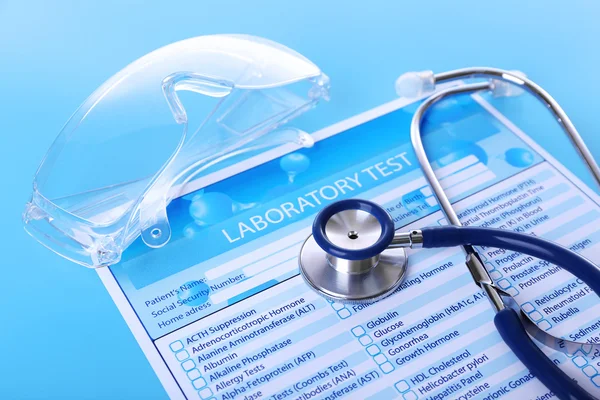 Laboratory test list, stethoscope and eyeglasses — Stock Photo ...