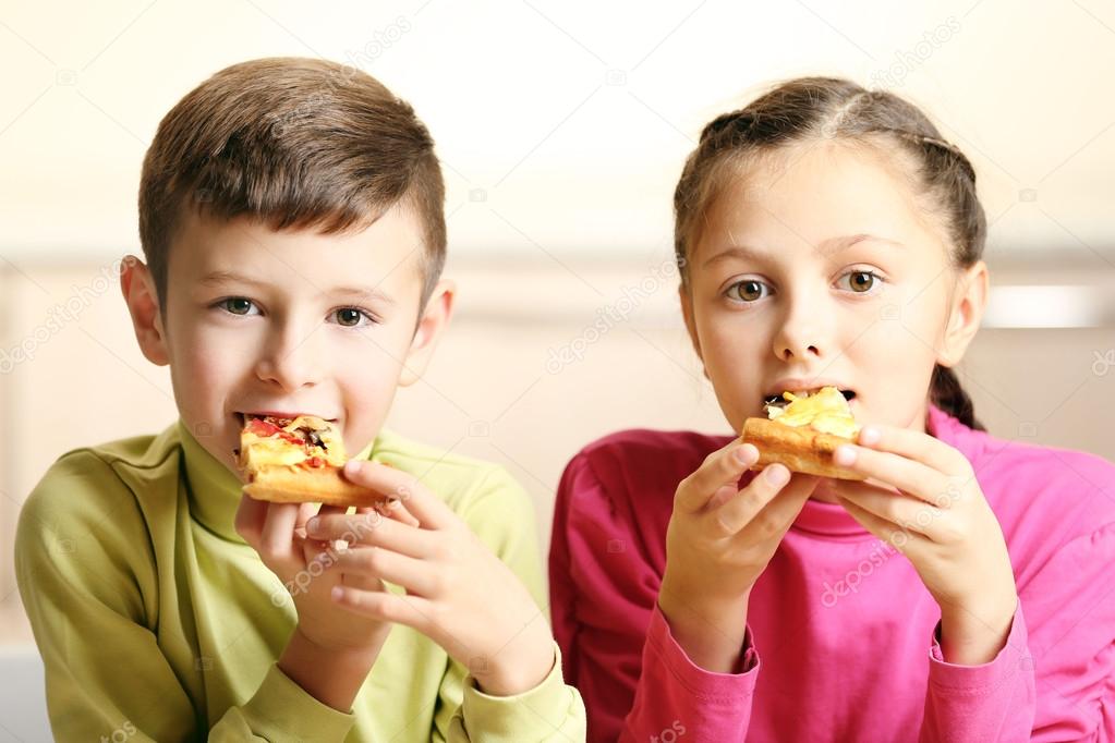 niños comiendo pizza — Foto de stock © belchonock #97728840