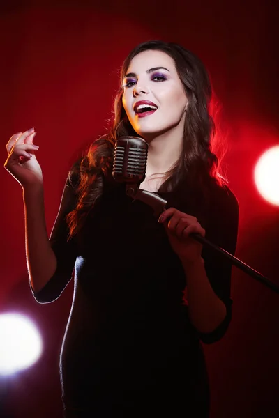 Attractive female singer Stock Photo by ©belchonock 100925862