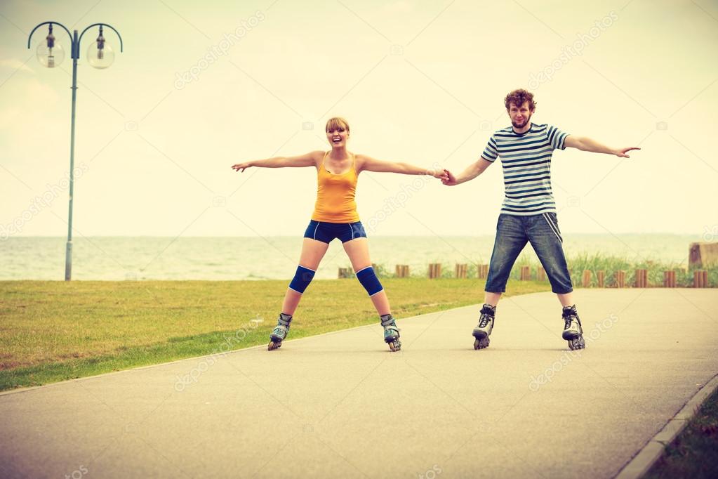 Young couple on roller skates riding outdoors Stock Photo by ©Anetlanda ...
