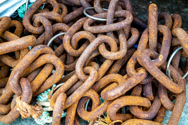 Old rusty chain stored on harbour pier - Stock Image - Everypixel