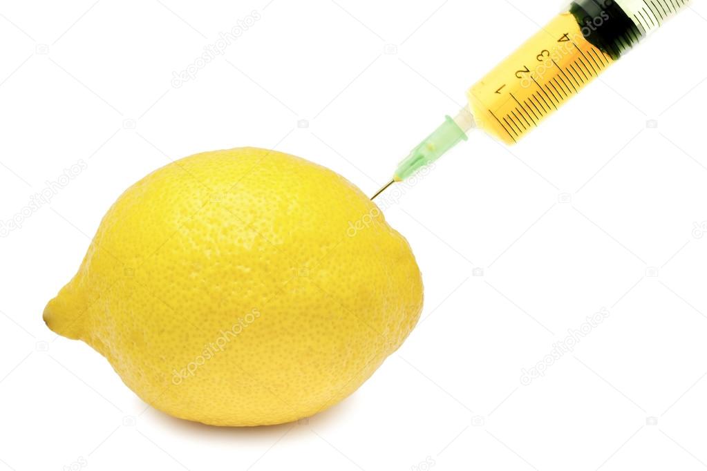 Medical injection with liquid and a yellow lemon Stock Photo by ...
