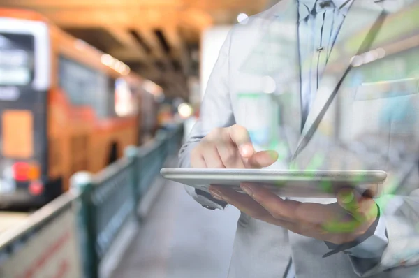 Business Man using Mobile Digital tablet in Bus Station - Stock Image ...