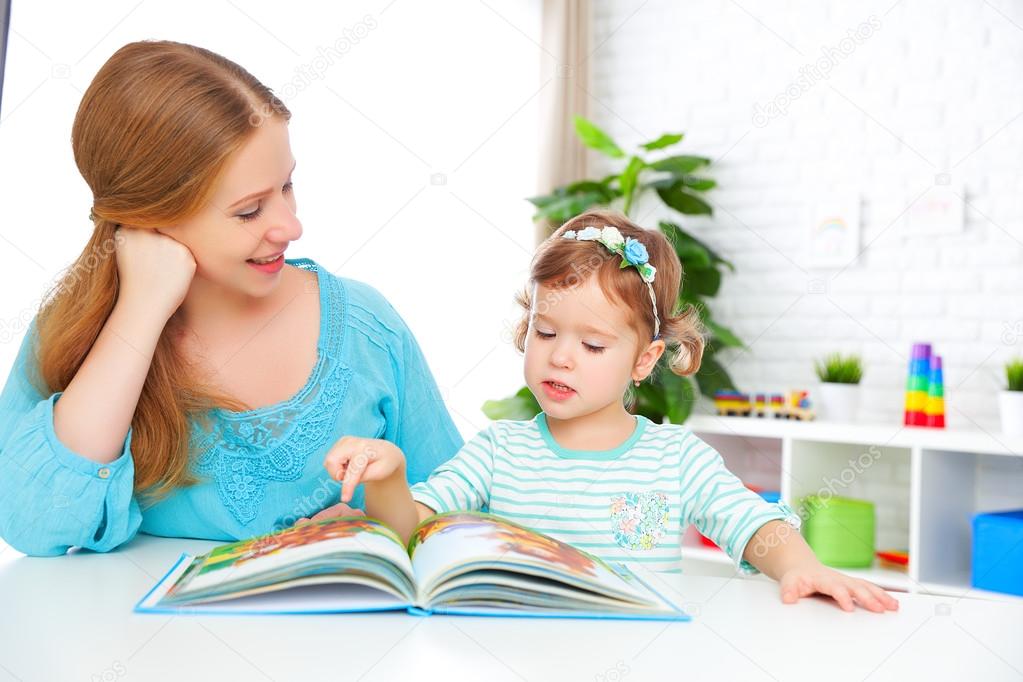 Mother and child reading book at home Stock Photo by ©evgenyataman 95869294