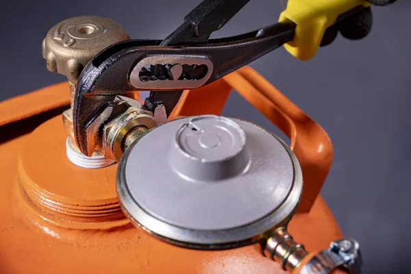 Installation of the reducer to the gas cylinder. Installation work on ...