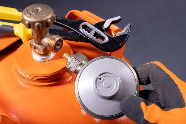 Installation of the reducer to the gas cylinder. Installation work on ...