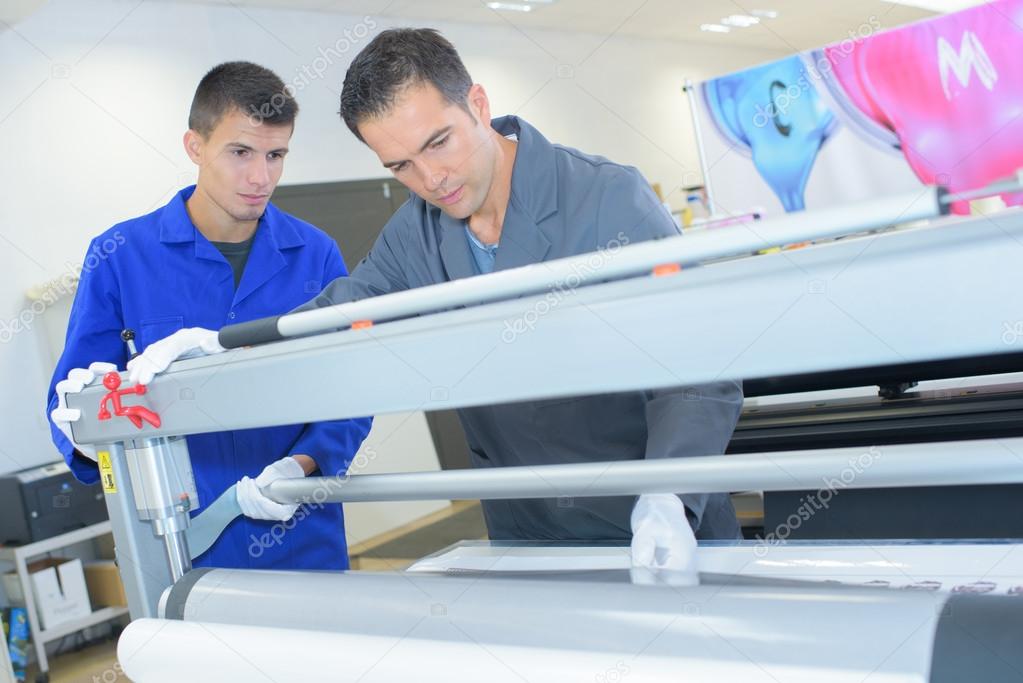 Men using printing machine Stock Photo by ©photography33 107928994
