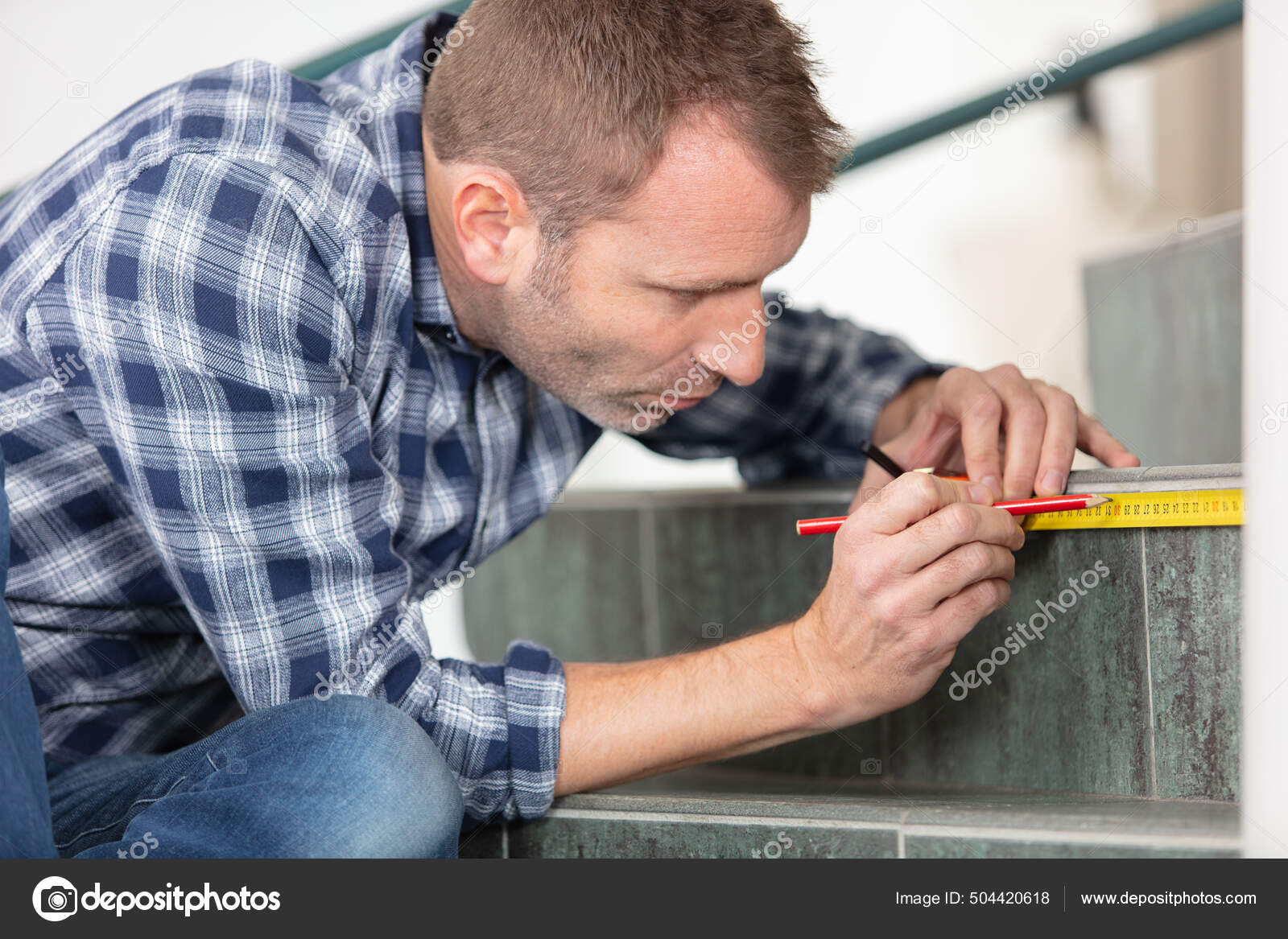 Young Worker Using Tape Measure Measuring Staircases Stock Photo by ...