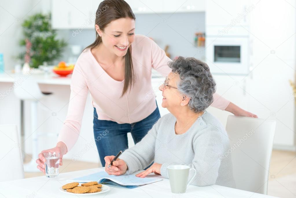 Carer helping woman at home — Stock Photo © photography33 #77597608