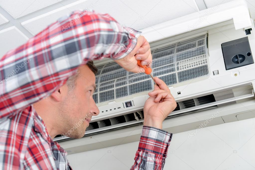 Man working on air conditioning unit Stock Photo by ©photography33 77951748