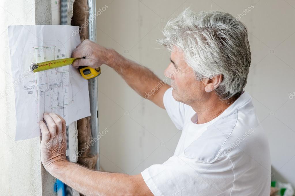 Mason measuring plans — Stock Photo © photography33 #82229706