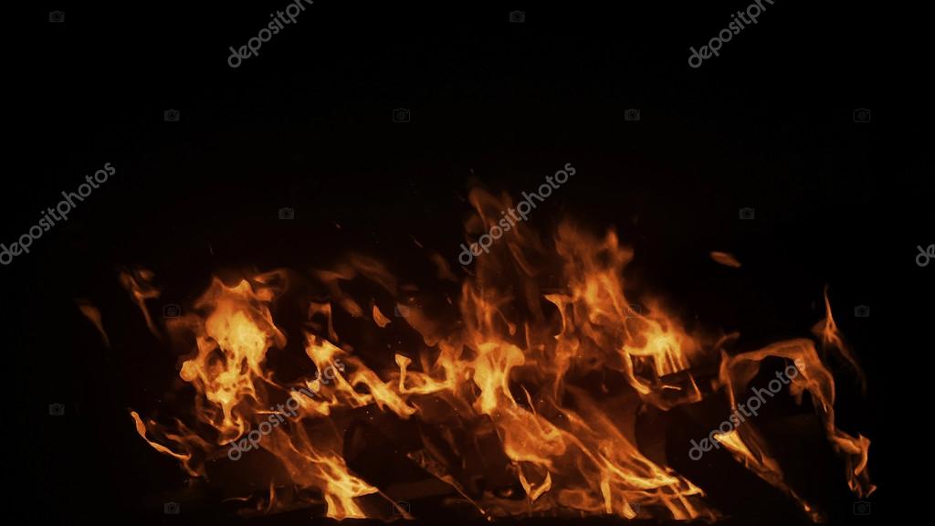Real small shot fire with particles on black background — Stock Photo ...
