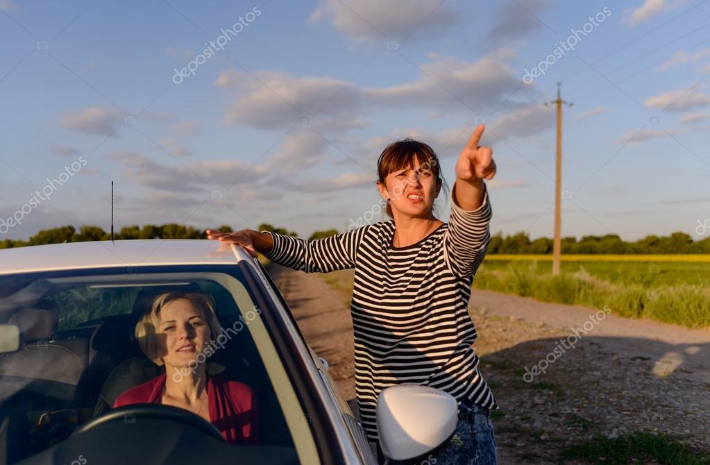 Woman giving directions to a lost driver Stock Photo by ©ampack 86071674