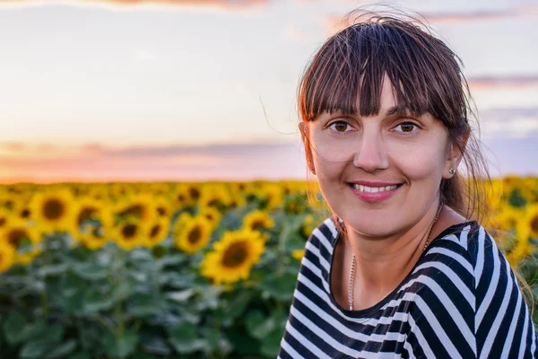 Smiling woman peering into the lens - Stock Image - Everypixel