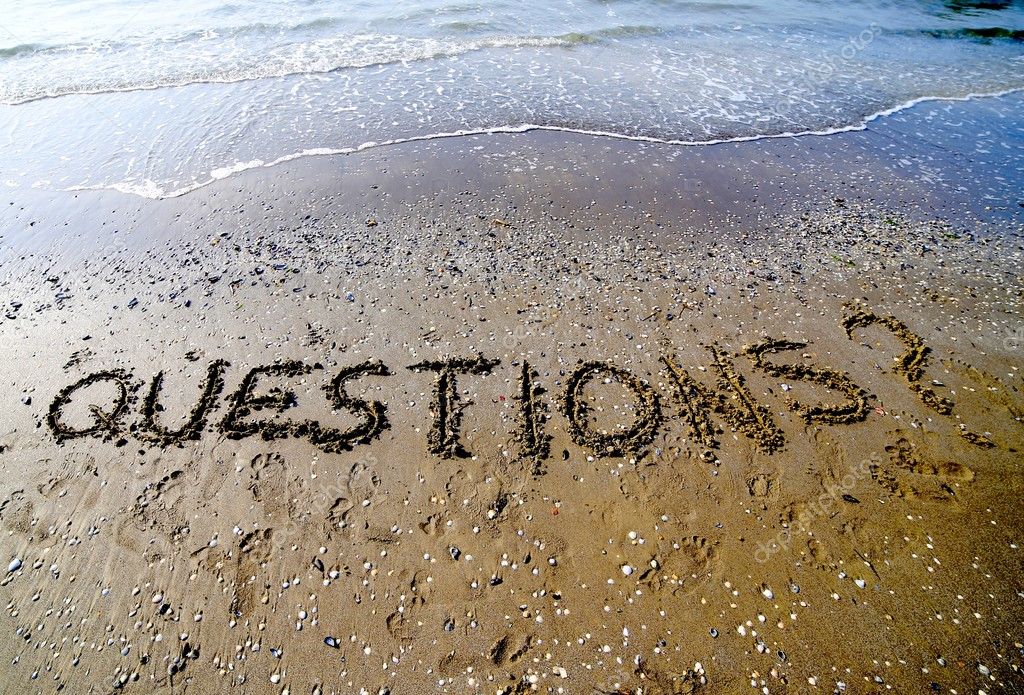 Questions with question mark written on the sand of the sea in s ...