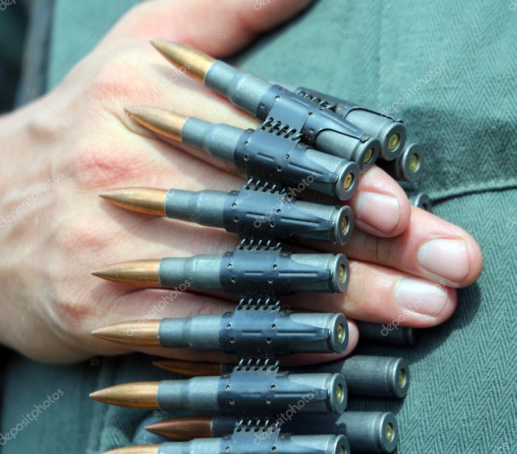 Soldier in uniform with bullets in his hand ready to open fire Stock ...