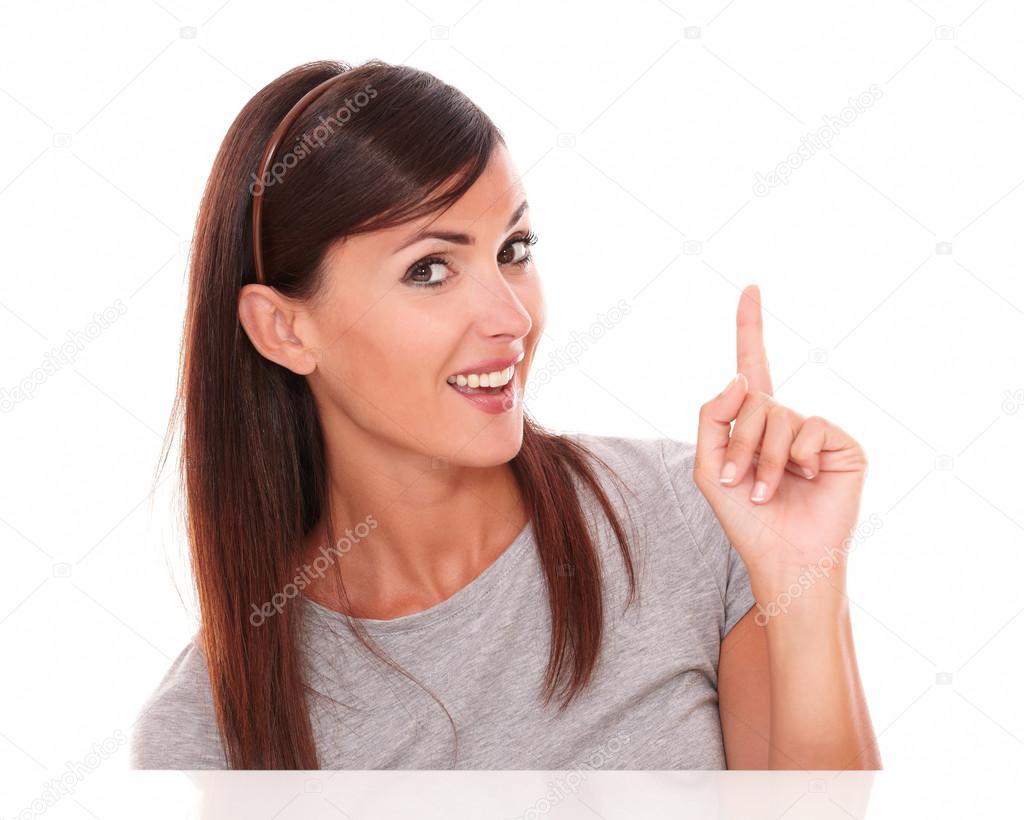 Attractive young woman pointing up and smiling Stock Photo by ...