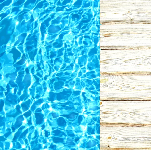Light wood skirting or pier at the pool or the sea. Clear blue water ...