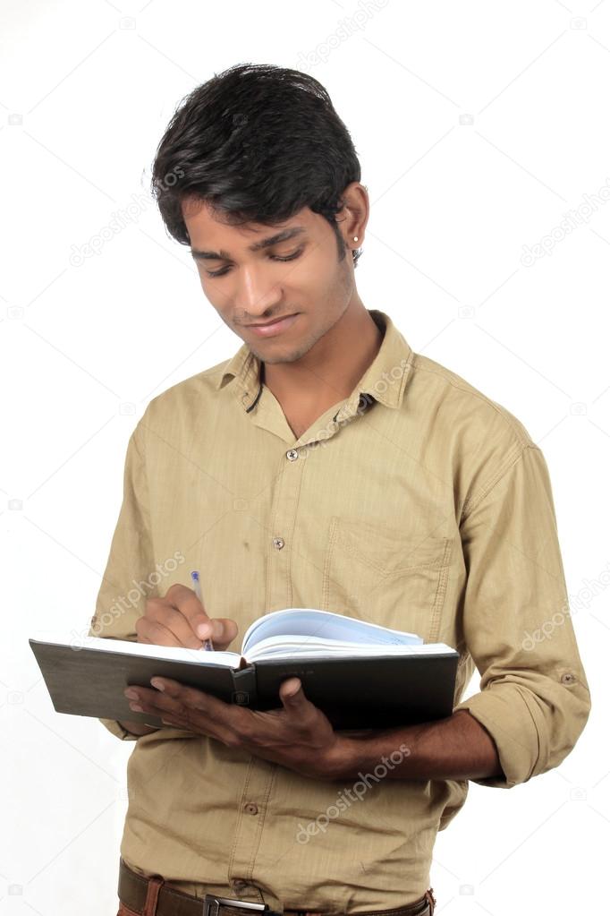 Beautiful Young Indian Boy writing a note in diary — Stock Photo ...