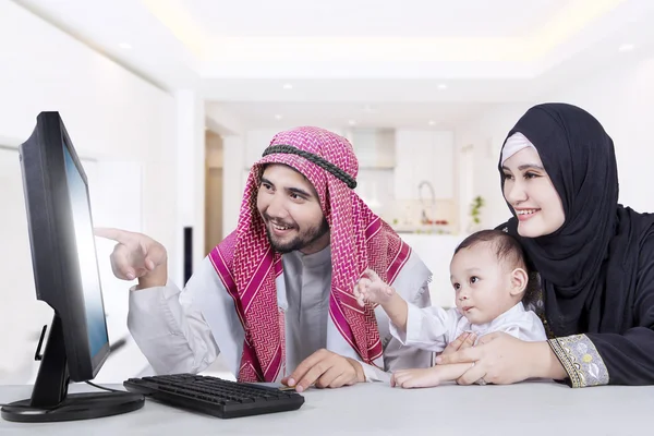 Middle eastern family using a computer - Stock Image - Everypixel