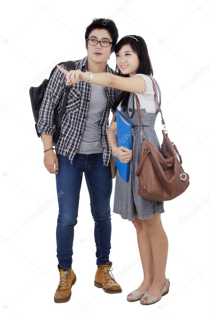 Two students pointing at something in studio Stock Photo by ...