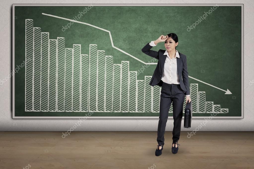 Depressed woman and declining graph Stock Photo by ©realinemedia 124719184