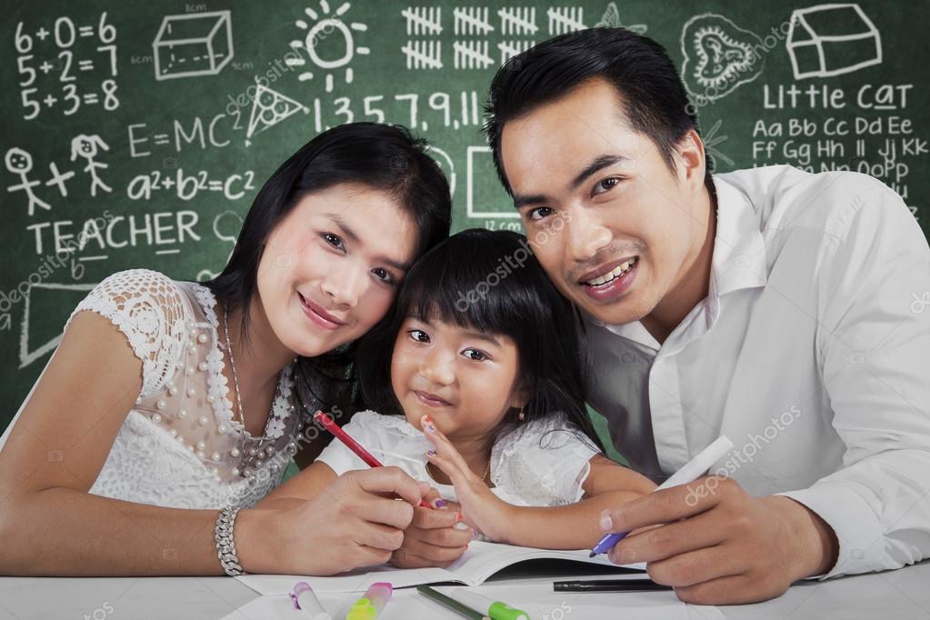 Beautiful family doing schoolwork Stock Photo by ©realinemedia 68158083