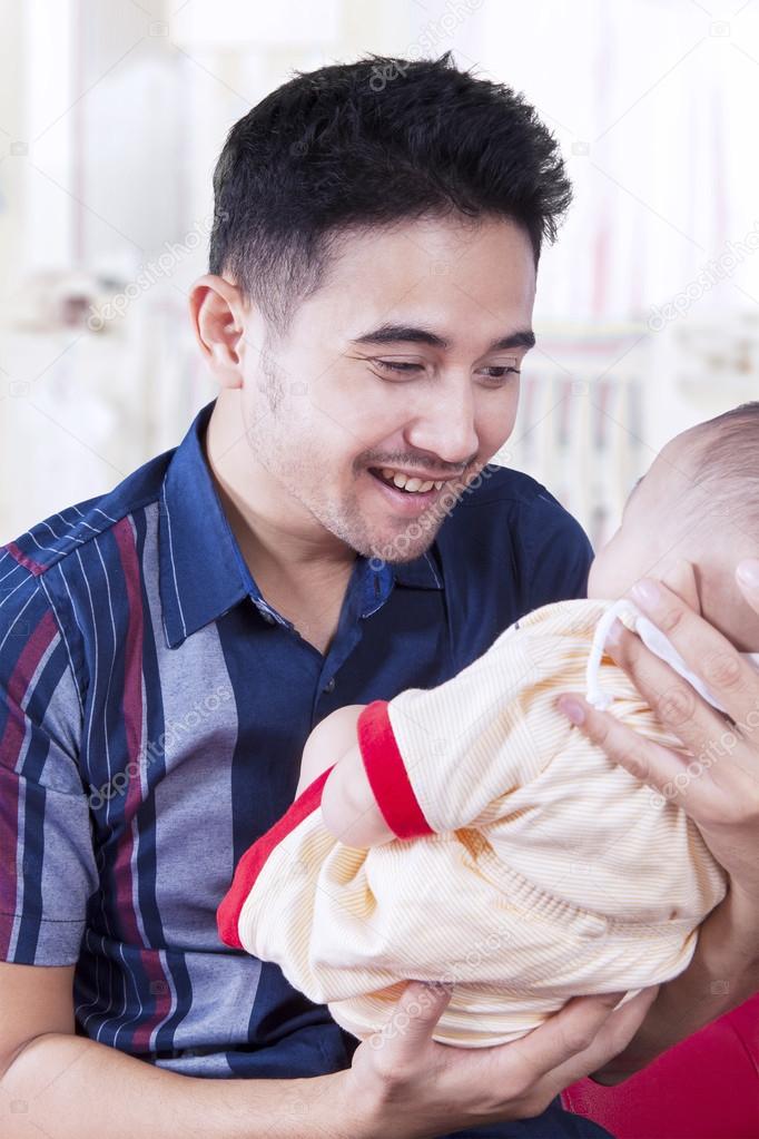 Joyful dad smiling on his baby — Stock Photo © realinemedia #75829749