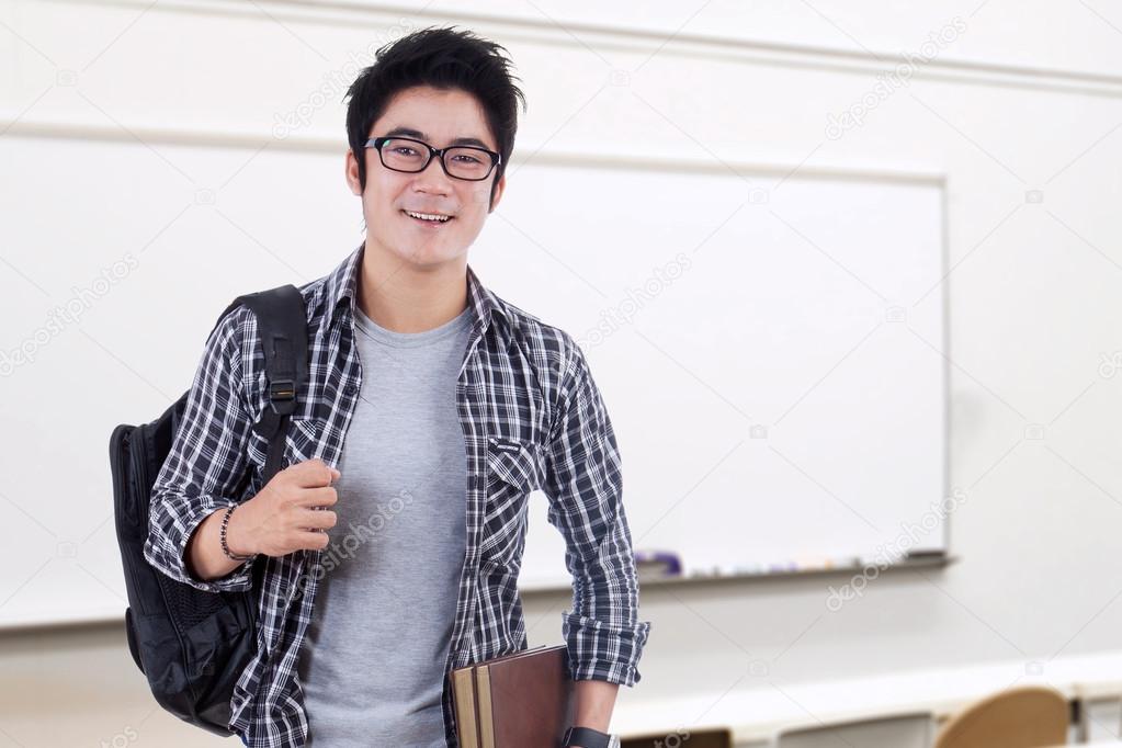 Handsome chinese student standing in class — Stock Photo © realinemedia ...