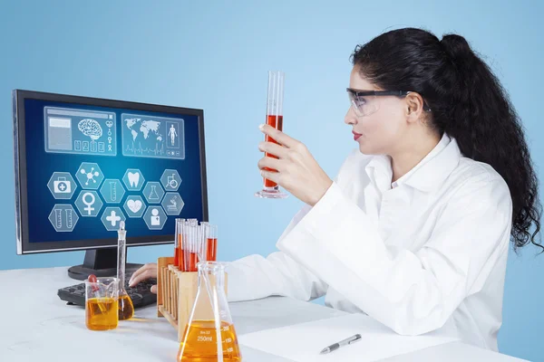 Researcher using computer while making experiment - Stock Image ...