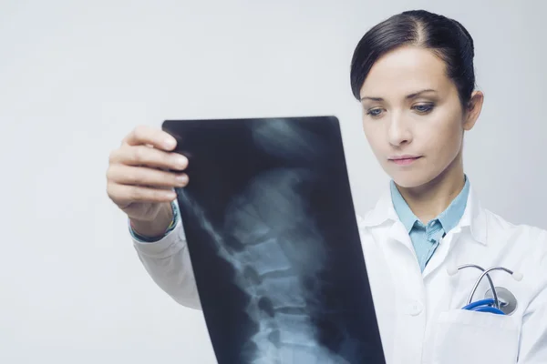 Surgeon analyzing x-ray report Stock Photo by ©londondeposit 34012919