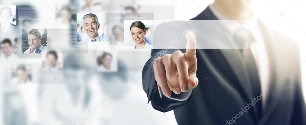 Businessman using a touch screen Stock Photo by ©stokkete 75485113