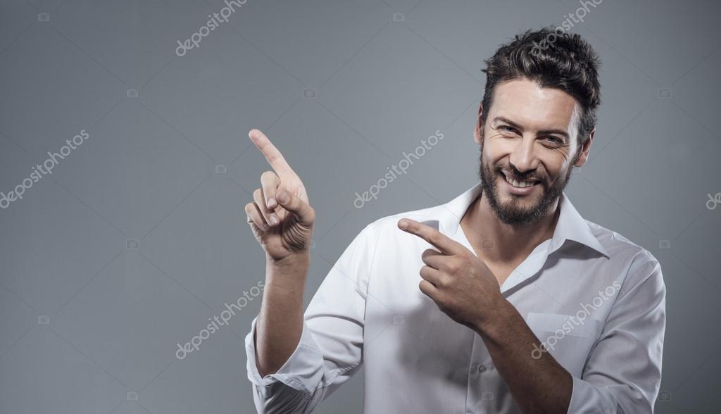 Smiling cool man pointing up — Stock Photo © stokkete #75489457