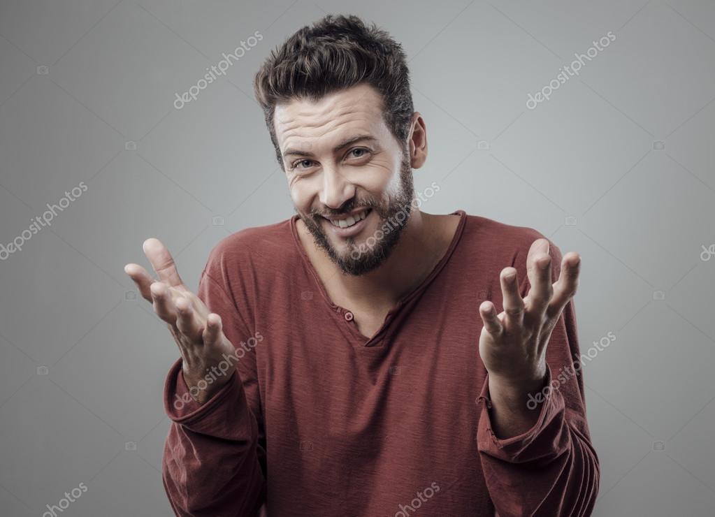 Man shrugging and smiling Stock Photo by ©stokkete 82874930