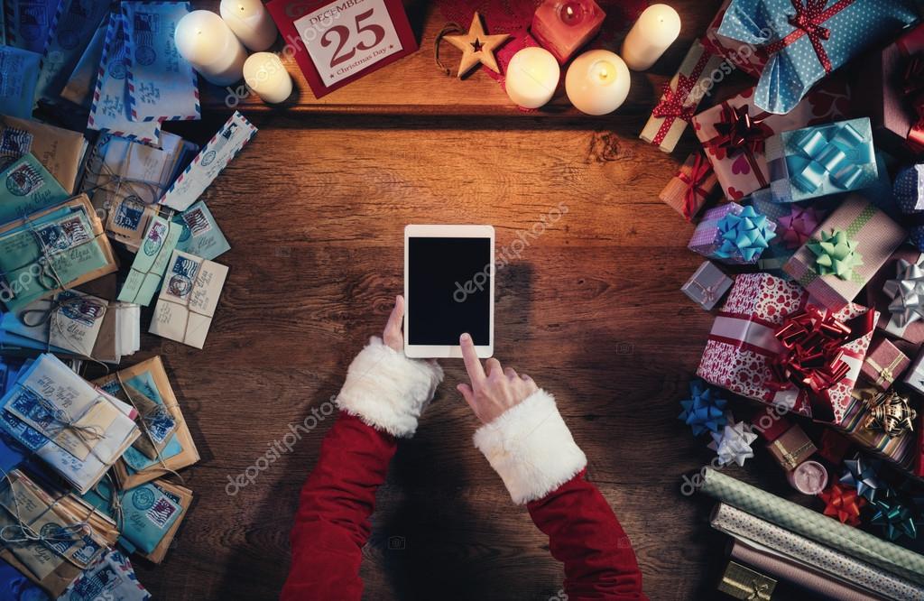 Santa using a digital tablet — Stock Photo © stokkete #90755116
