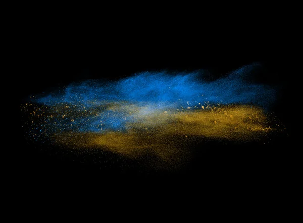 Blue and yellow powder explosion isolated on black - Stock Image ...