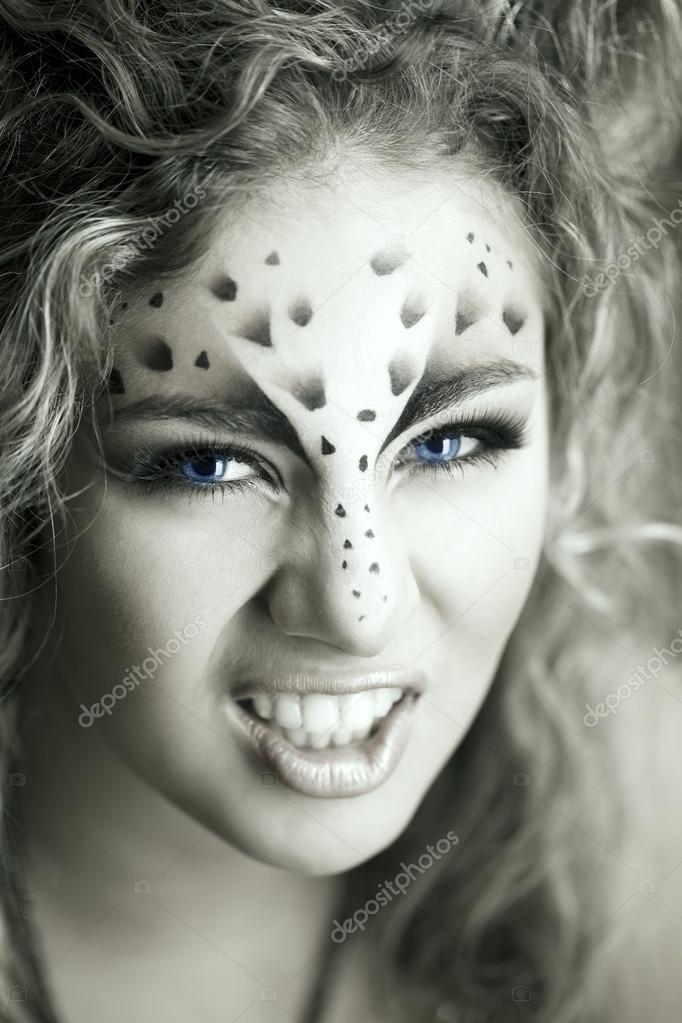 Beauty woman with makeup in snow leopard style. Fashion makeup m ...
