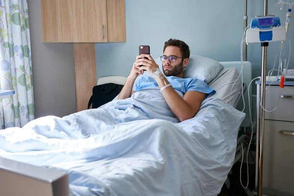 Young Man Lying Hospital Bed Getting Intravenous Drip Treatment Using ...